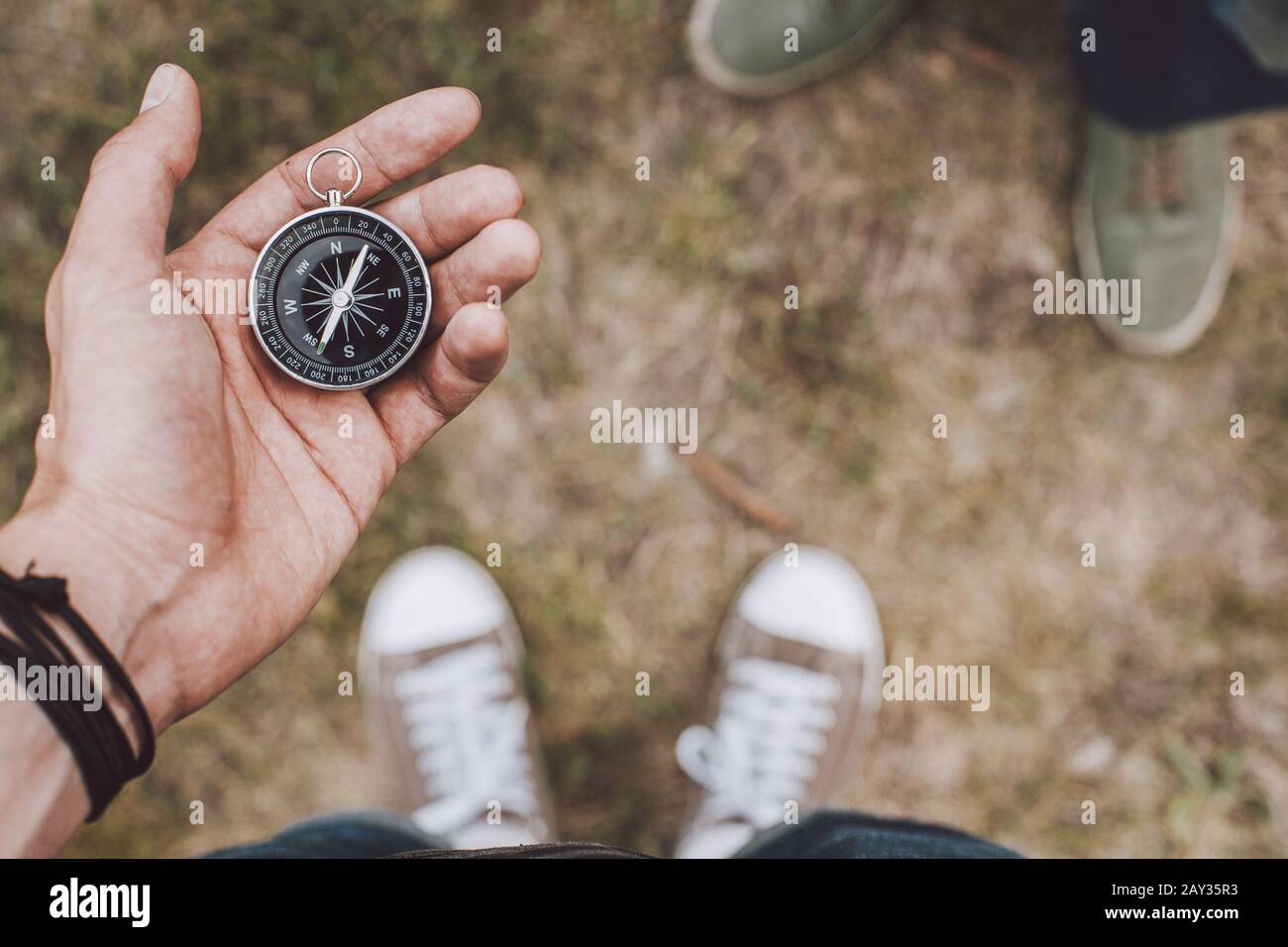 Man hand holding compass hi-res stock photography and images - Alamy