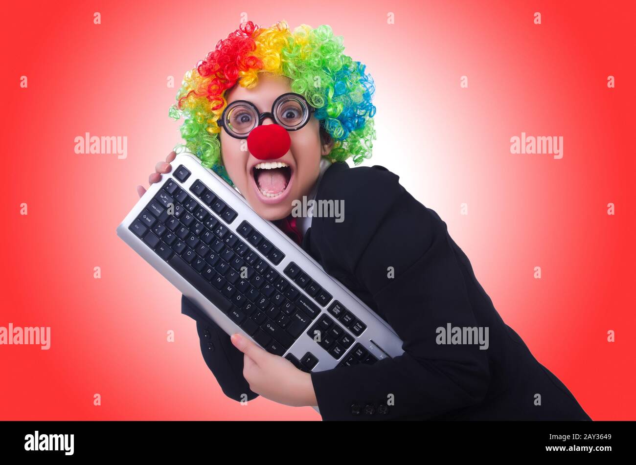 Funny clown with keyboard on white Stock Photo - Alamy