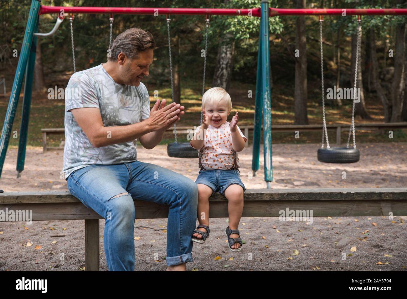 Father playing with son on playground Stock Photo - Alamy