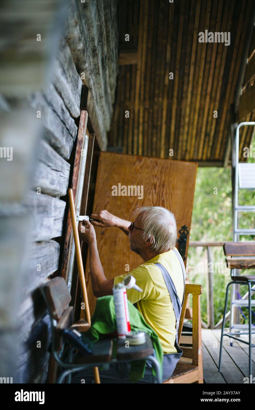 Man repairing house Stock Photo - Alamy