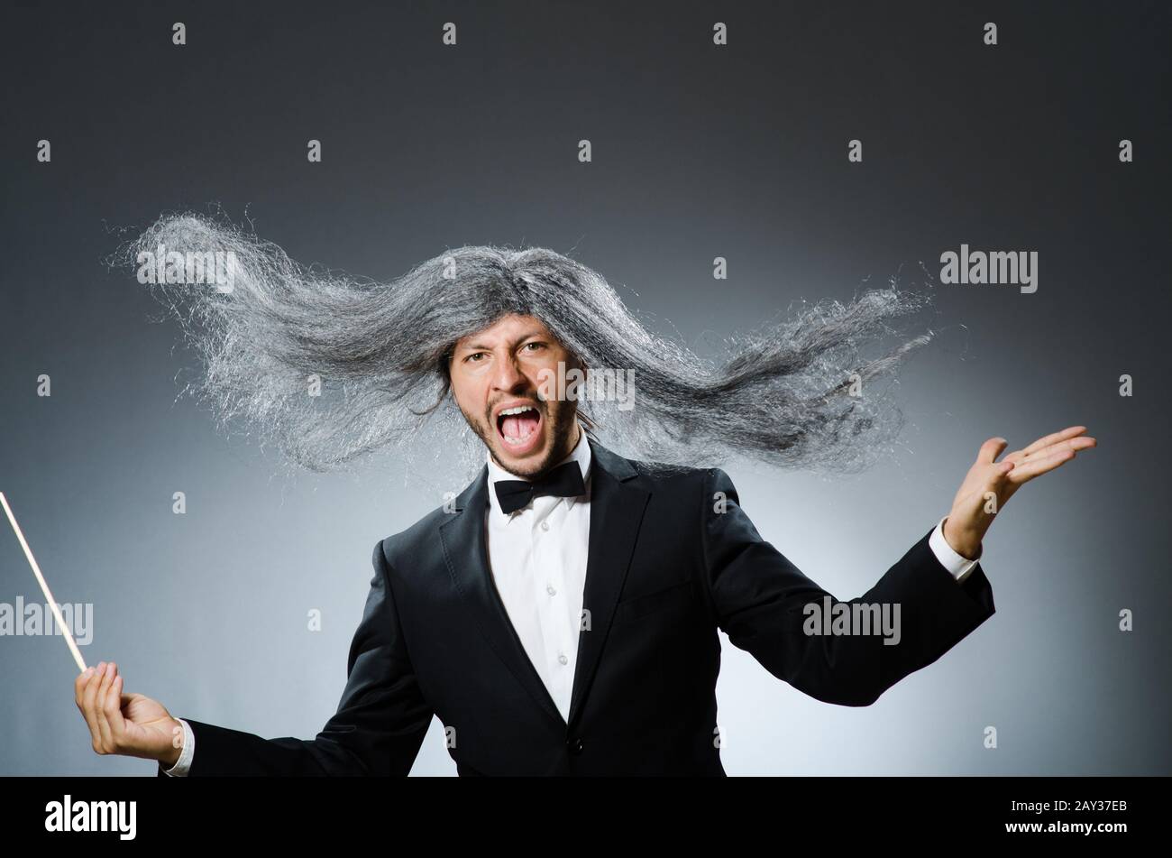 Funny conductor with long grey hair Stock Photo - Alamy