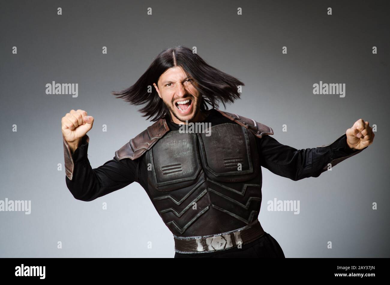 Angry warrior against dark background Stock Photo - Alamy