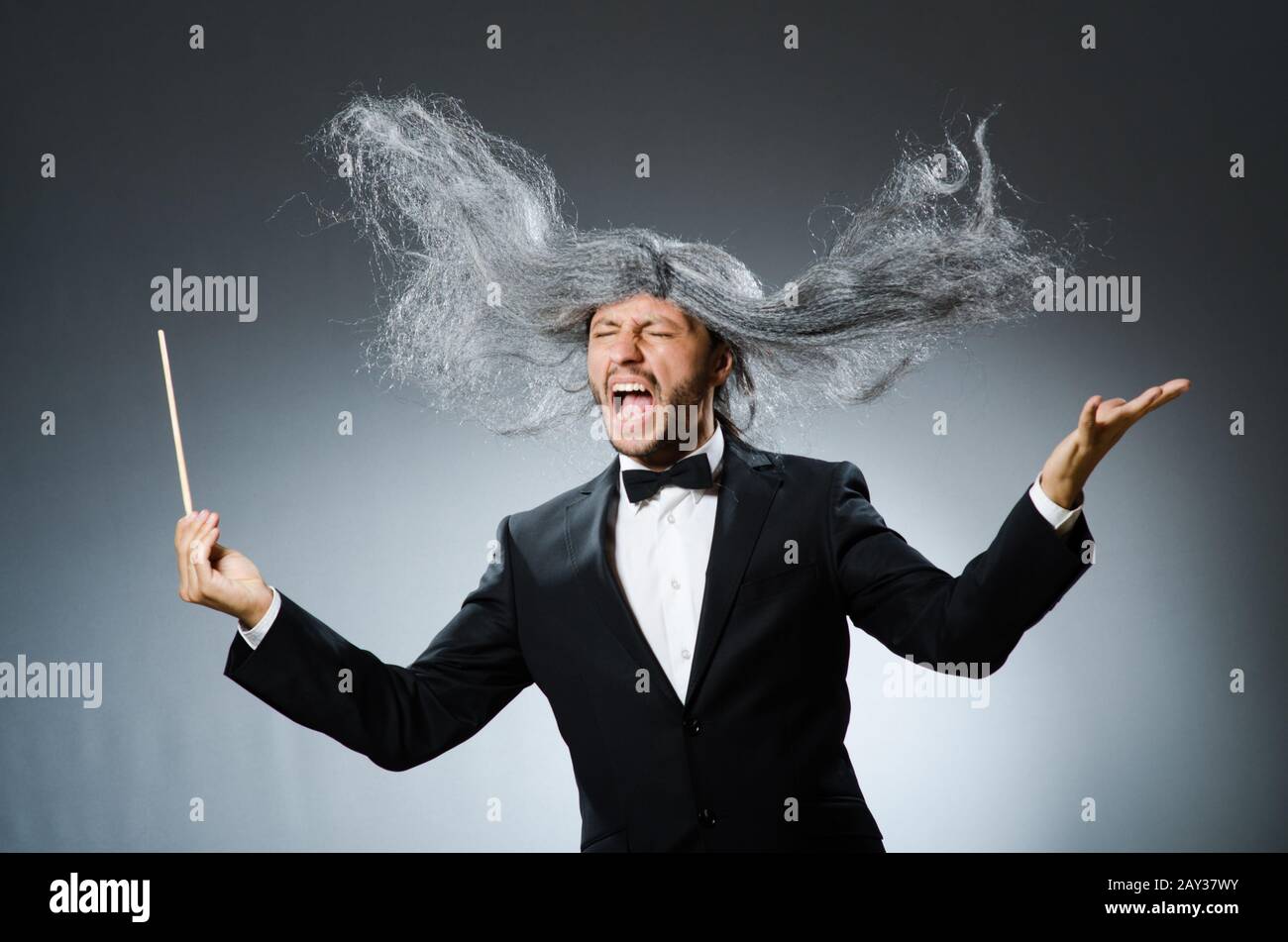 Funny conductor with long grey hair Stock Photo - Alamy