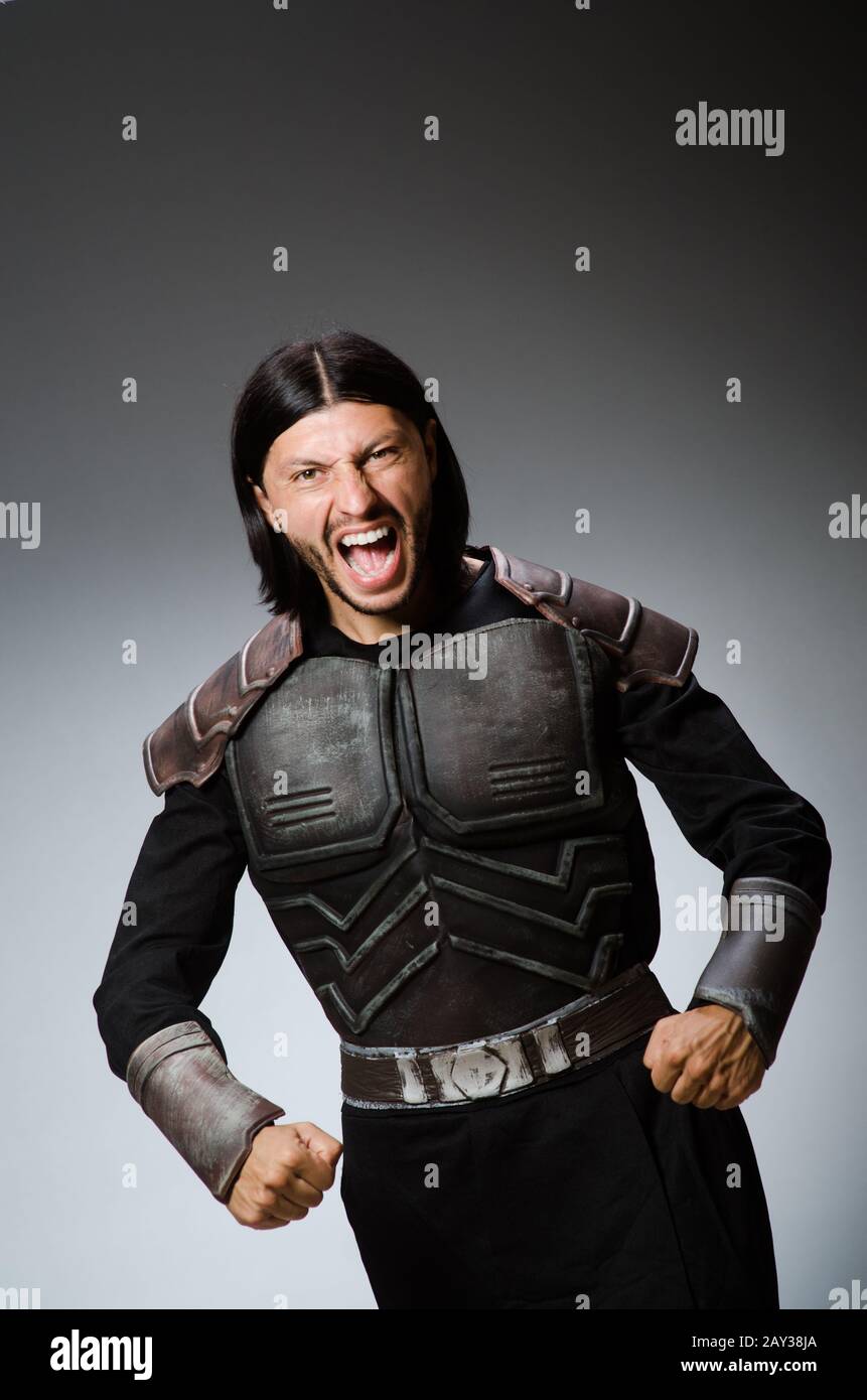Angry warrior against dark background Stock Photo - Alamy