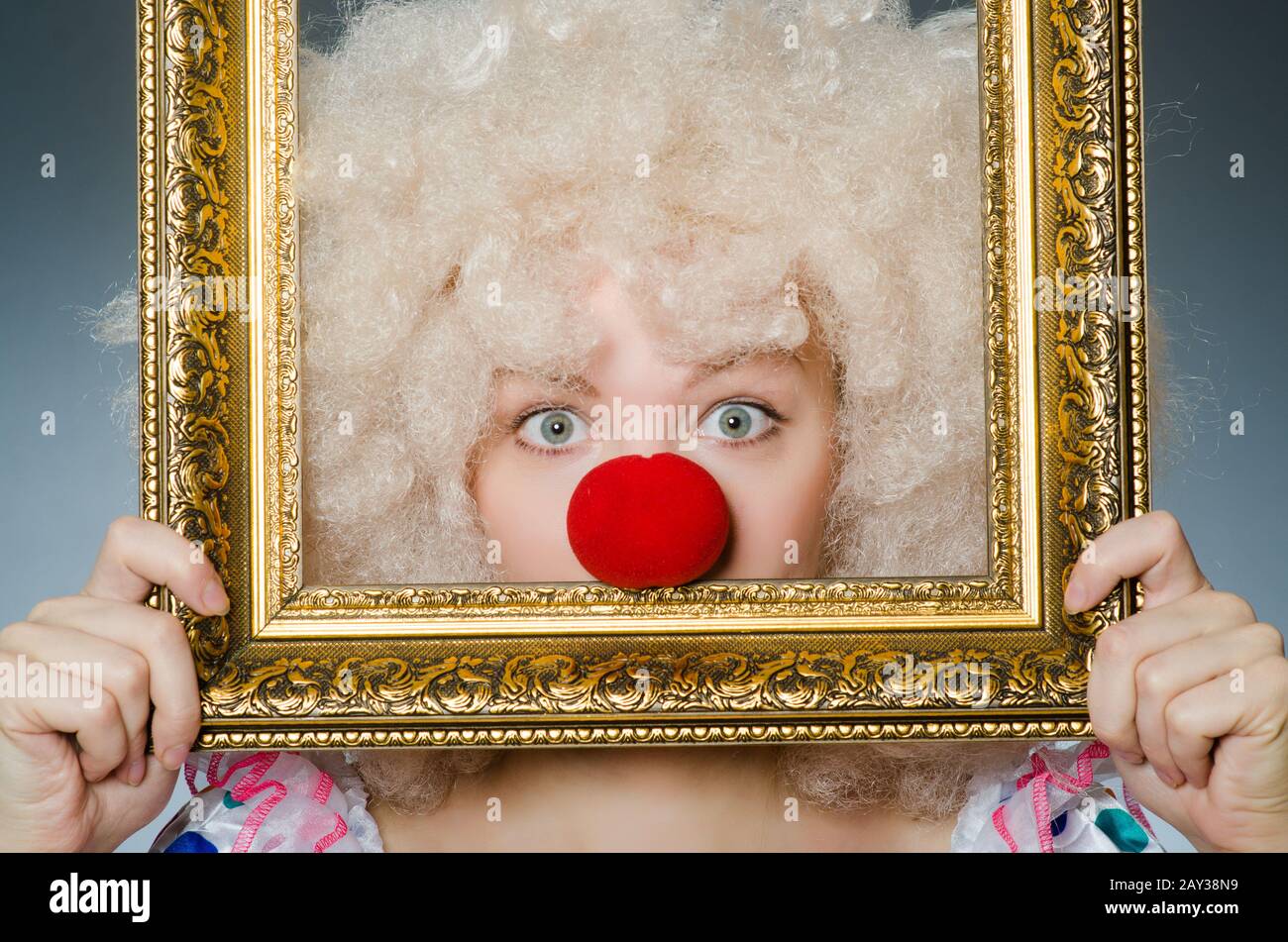 Funny clown with picture frame Stock Photo - Alamy