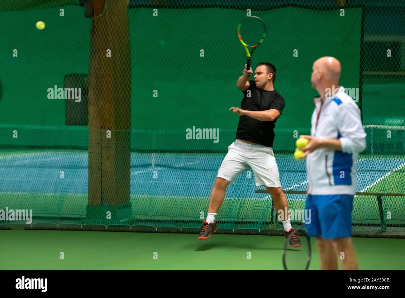 Adult men playing tennis hi-res stock photography and images - Alamy