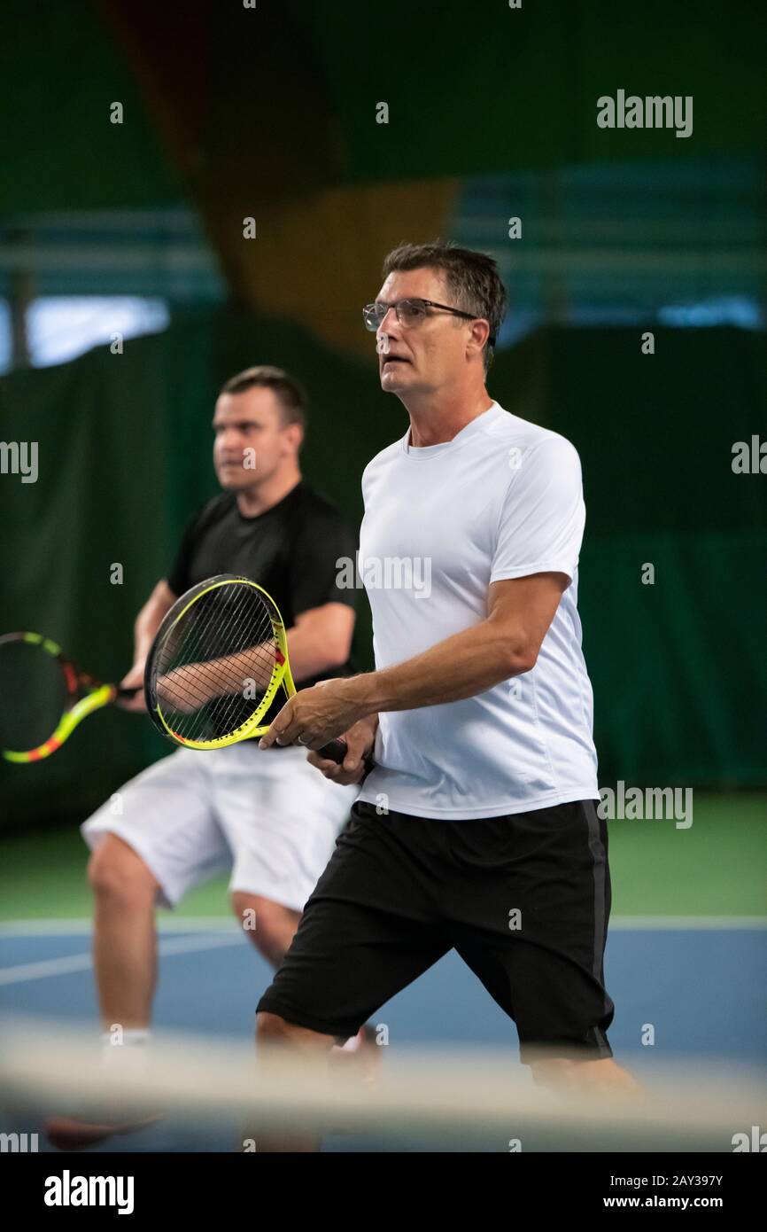 Adult men playing tennis hi-res stock photography and images - Alamy
