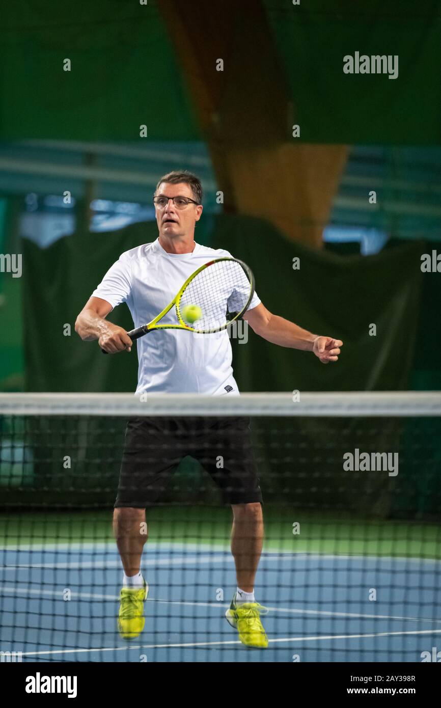 Senior man playing tennis hi-res stock photography and images - Alamy