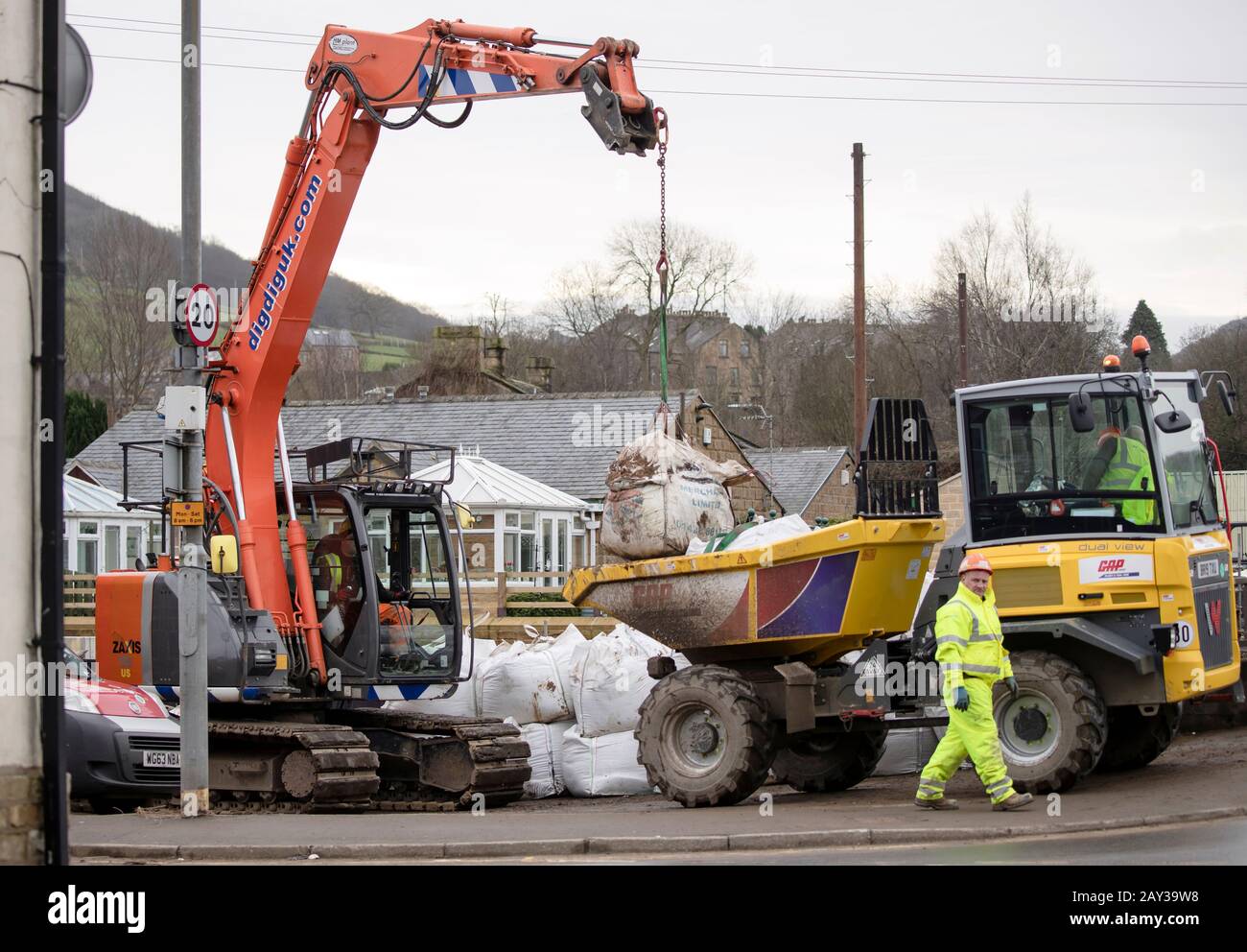 Workers construct flood defences in Mytholmroyd in the Upper Calder ...