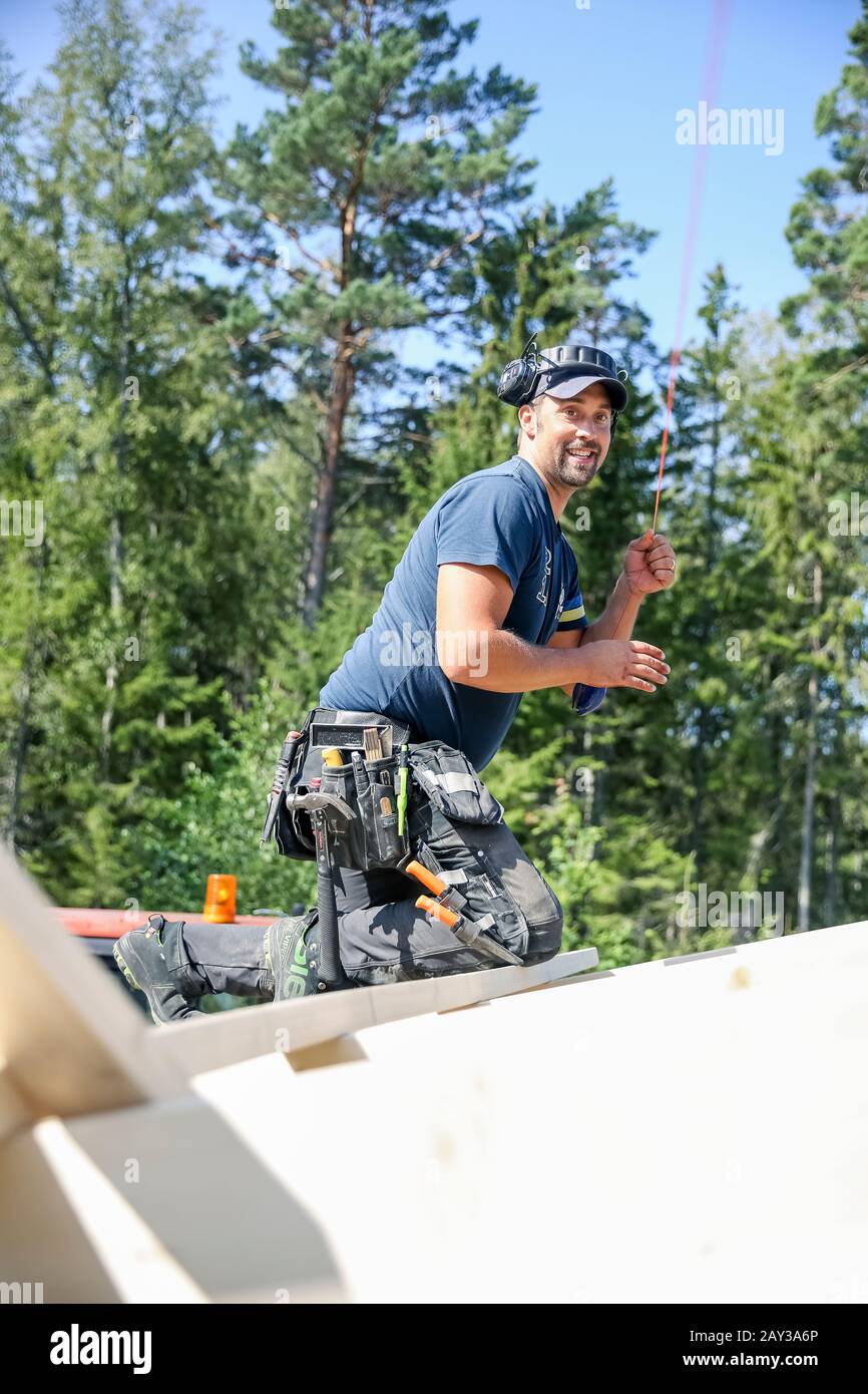 Smiling carpenter at work Stock Photo - Alamy