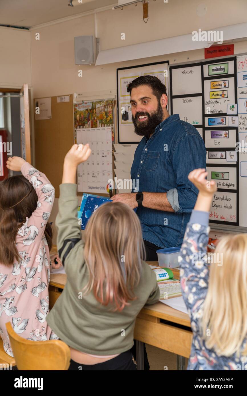 Teacher in classroom Stock Photo - Alamy