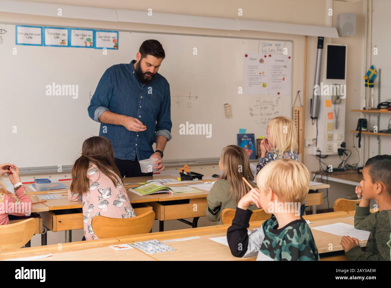 Teacher in classroom Stock Photo - Alamy