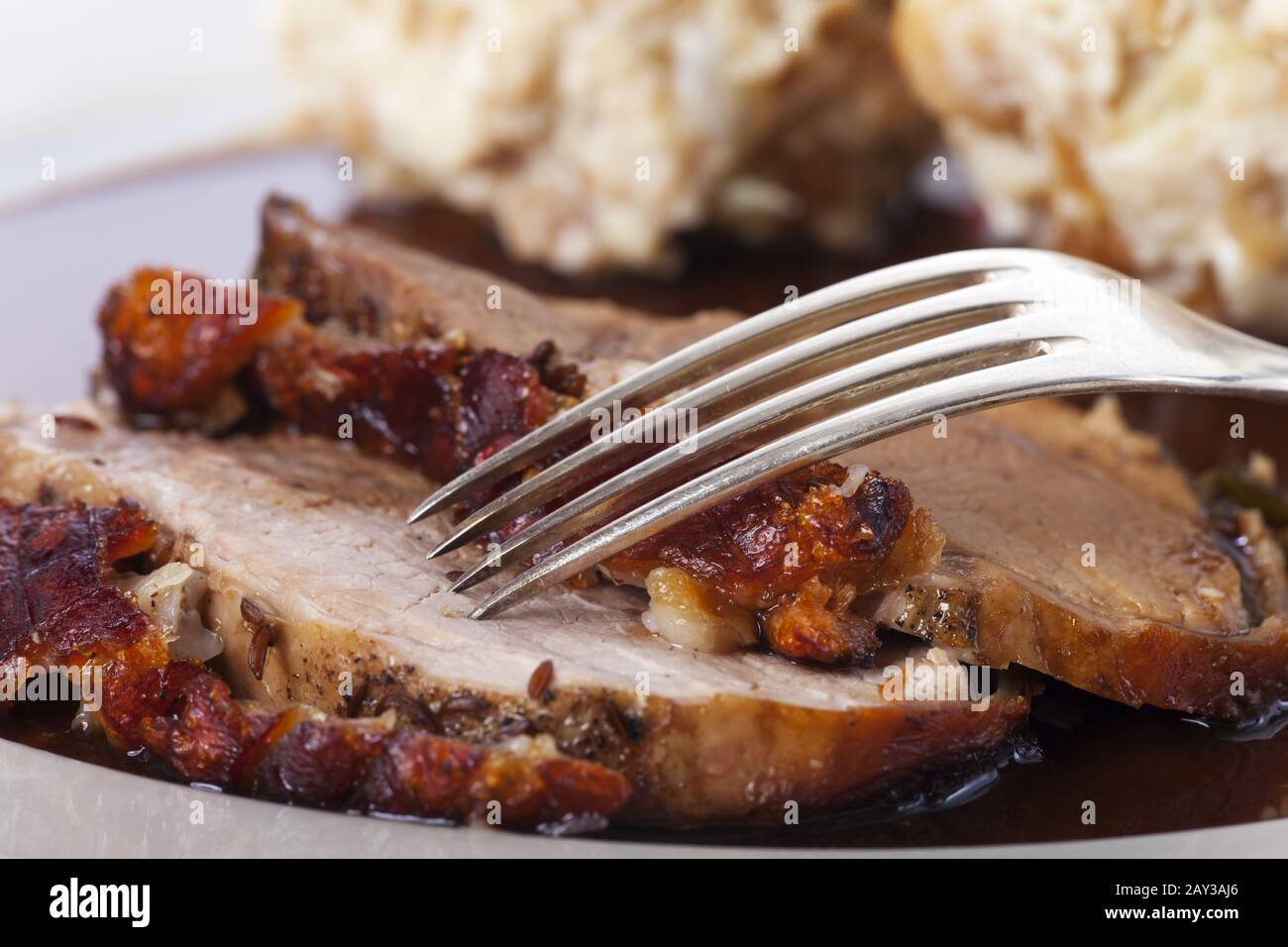 Fork on roast pork Stock Photo - Alamy