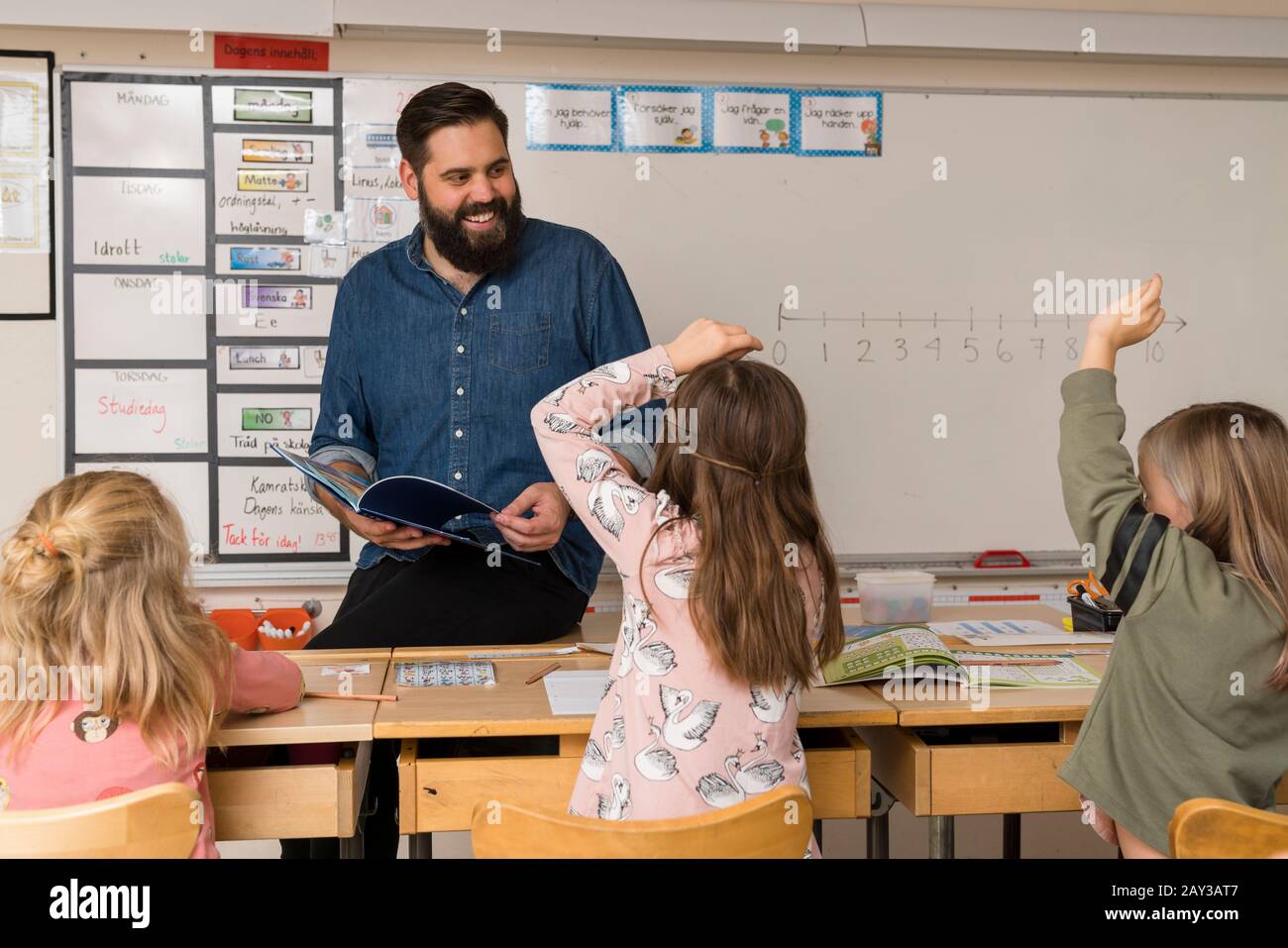 Teacher in classroom Stock Photo - Alamy