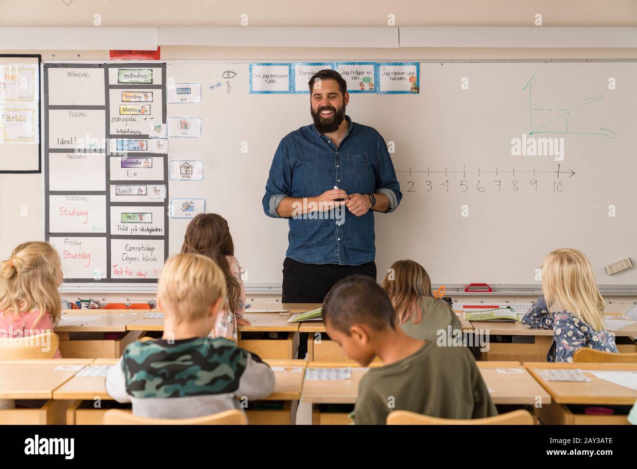 Teacher in classroom Stock Photo - Alamy