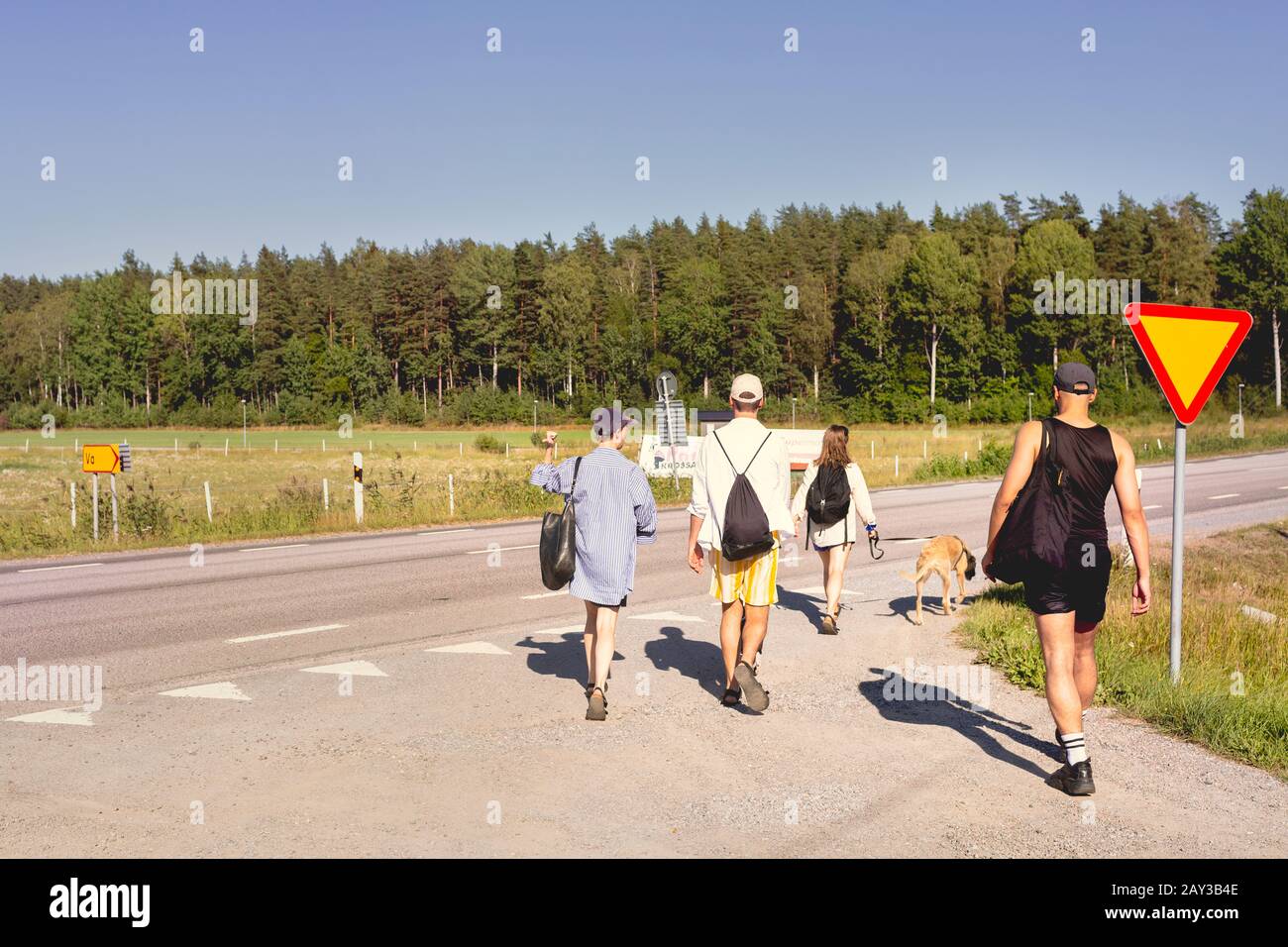 People walking along country road Stock Photo - Alamy