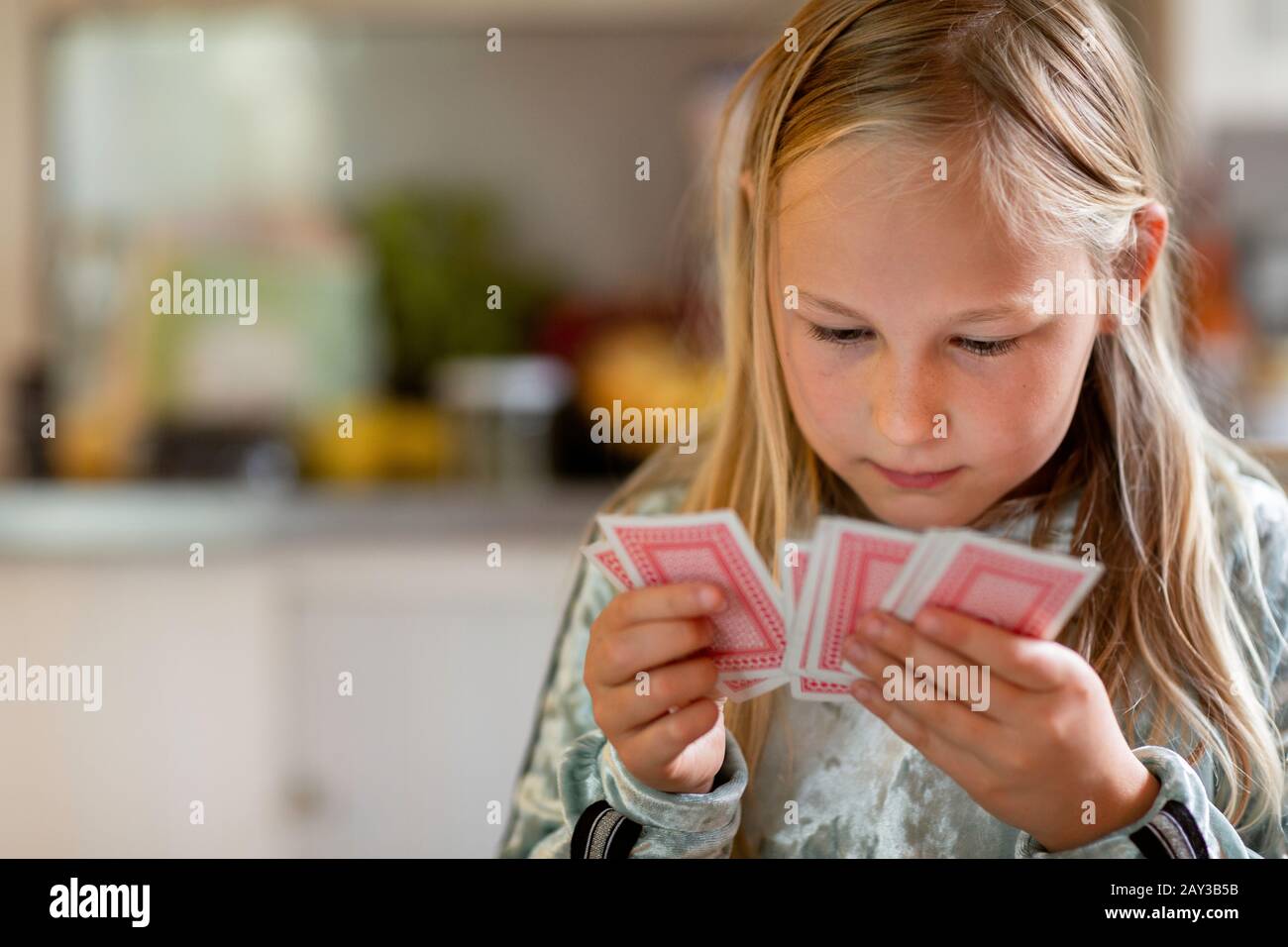 Girl playing cards Stock Photo - Alamy