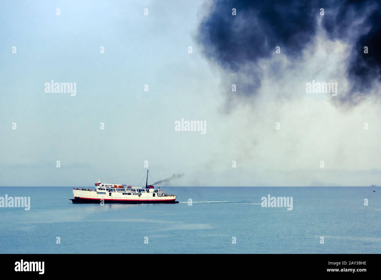 Exhaust pipe of ferry boat with black thick smoke coming out and sky ...