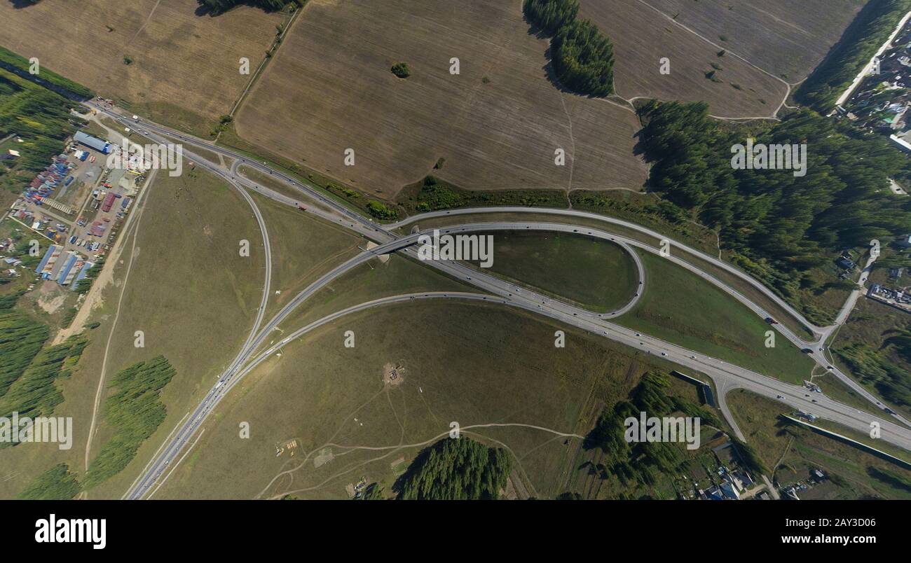 Aerial city view with crossroads, roads, houses, buildings, parks ...