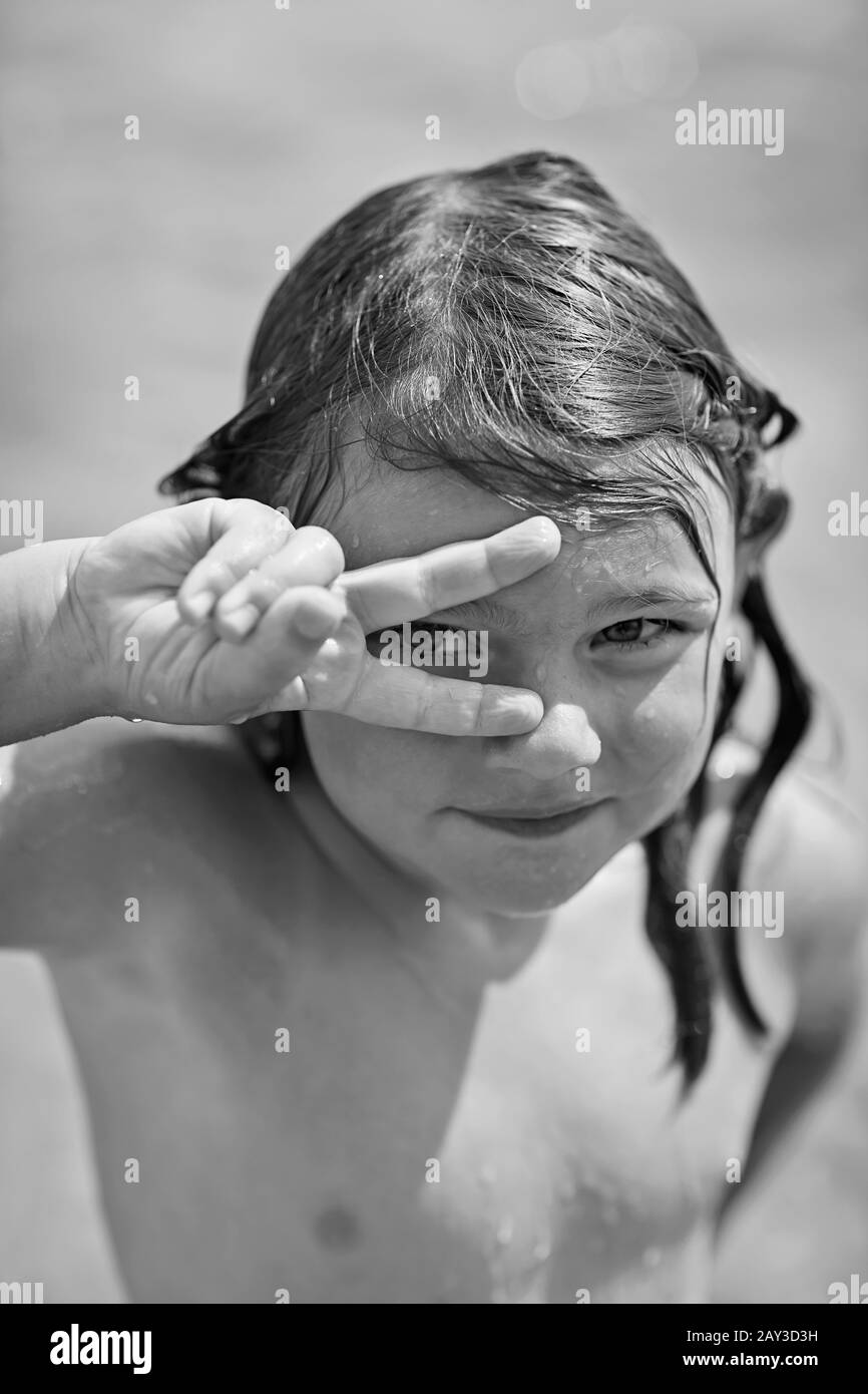 Portrait of girl showing peace sign Stock Photo - Alamy