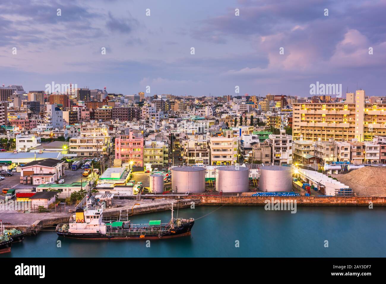 Naha, Okinawa, Japan industrial cityscape along Tomari Port at twilight ...