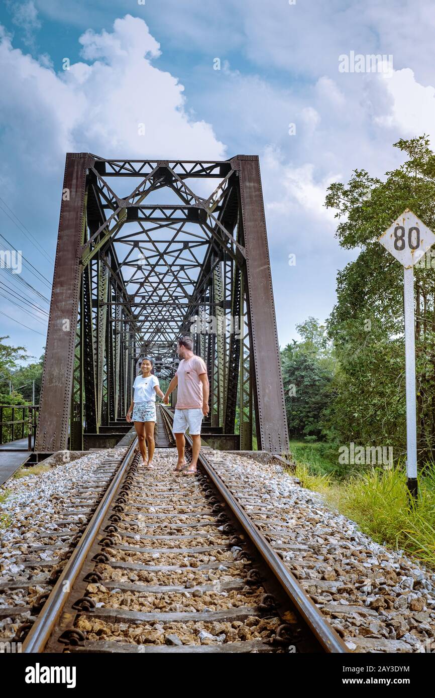Lang Suan railroad over the river in Chumphon Thailand, couple walking ...