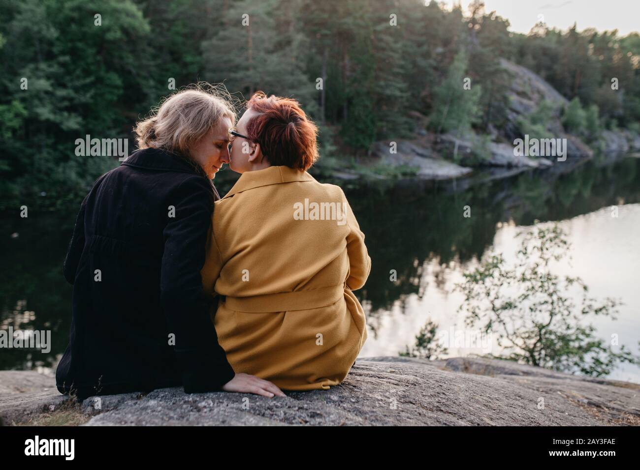 Female couple sitting together Stock Photo - Alamy