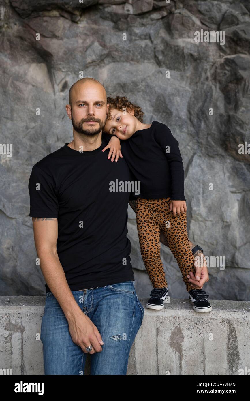 Father with daughter looking at camera Stock Photo - Alamy