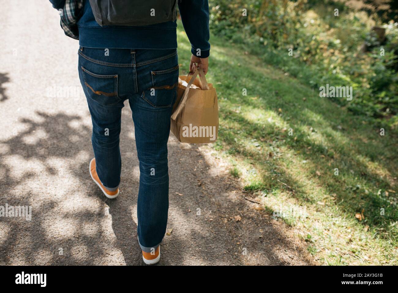 Man carrying paper bag Stock Photo - Alamy