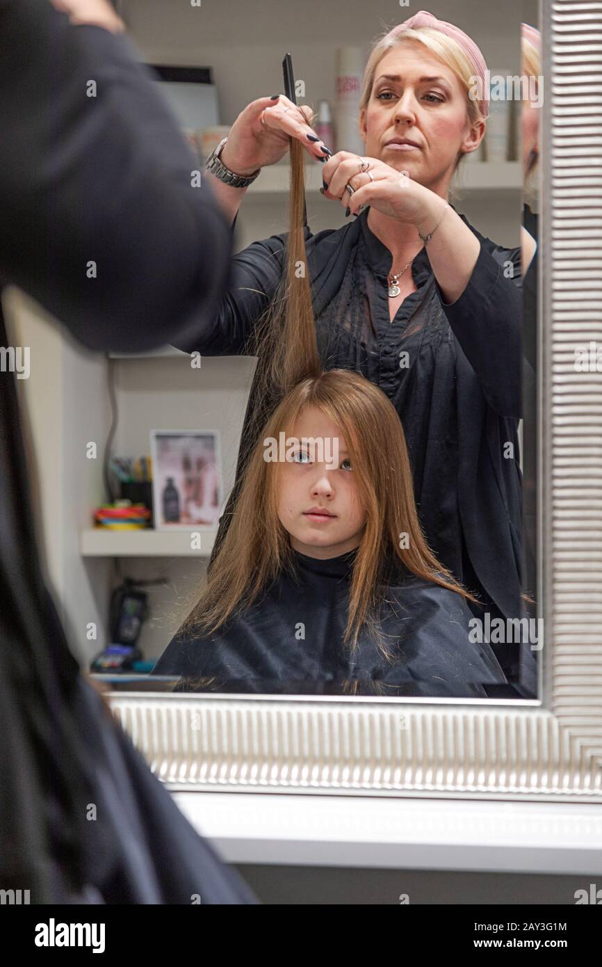 Girl having her hair cut Stock Photo - Alamy