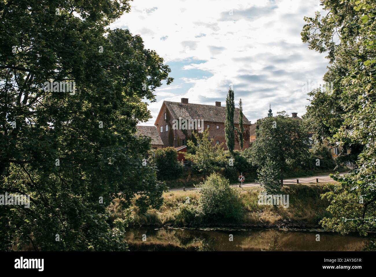 Building behind trees Stock Photo - Alamy