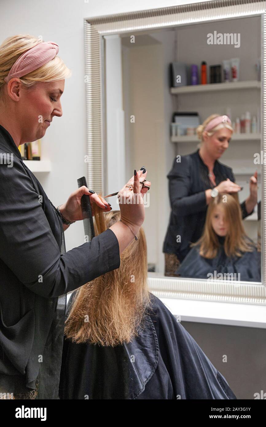 Girl having her hair cut Stock Photo - Alamy