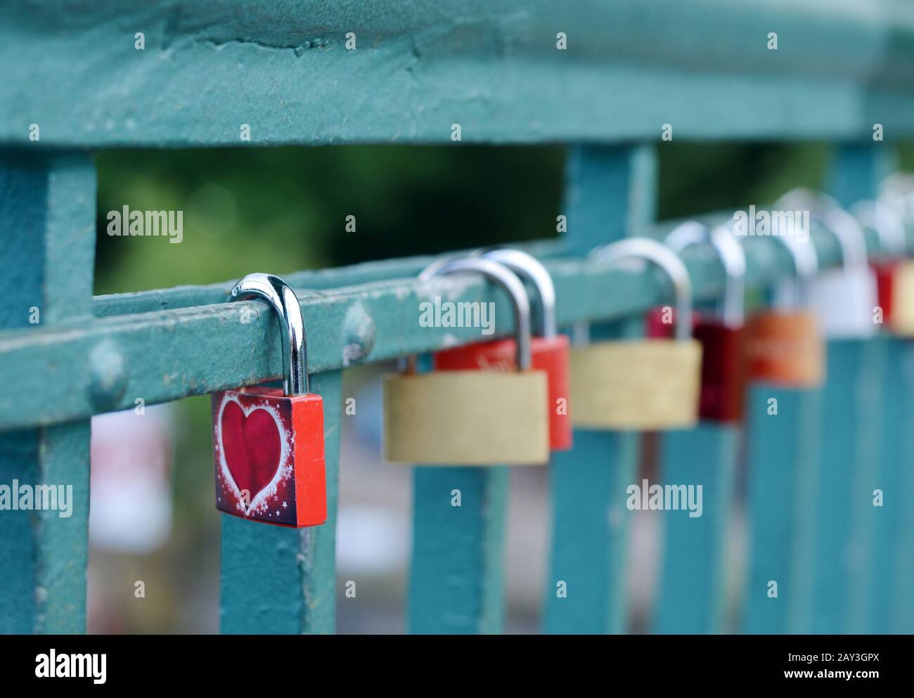 Padlocks on a metal bridge heart design Stock Photo - Alamy