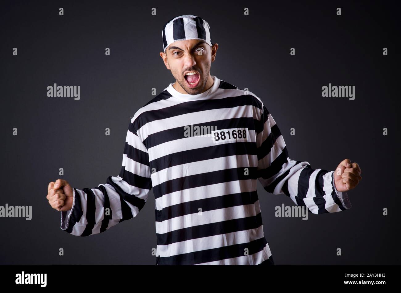 Angry prison inmate in dark room Stock Photo - Alamy