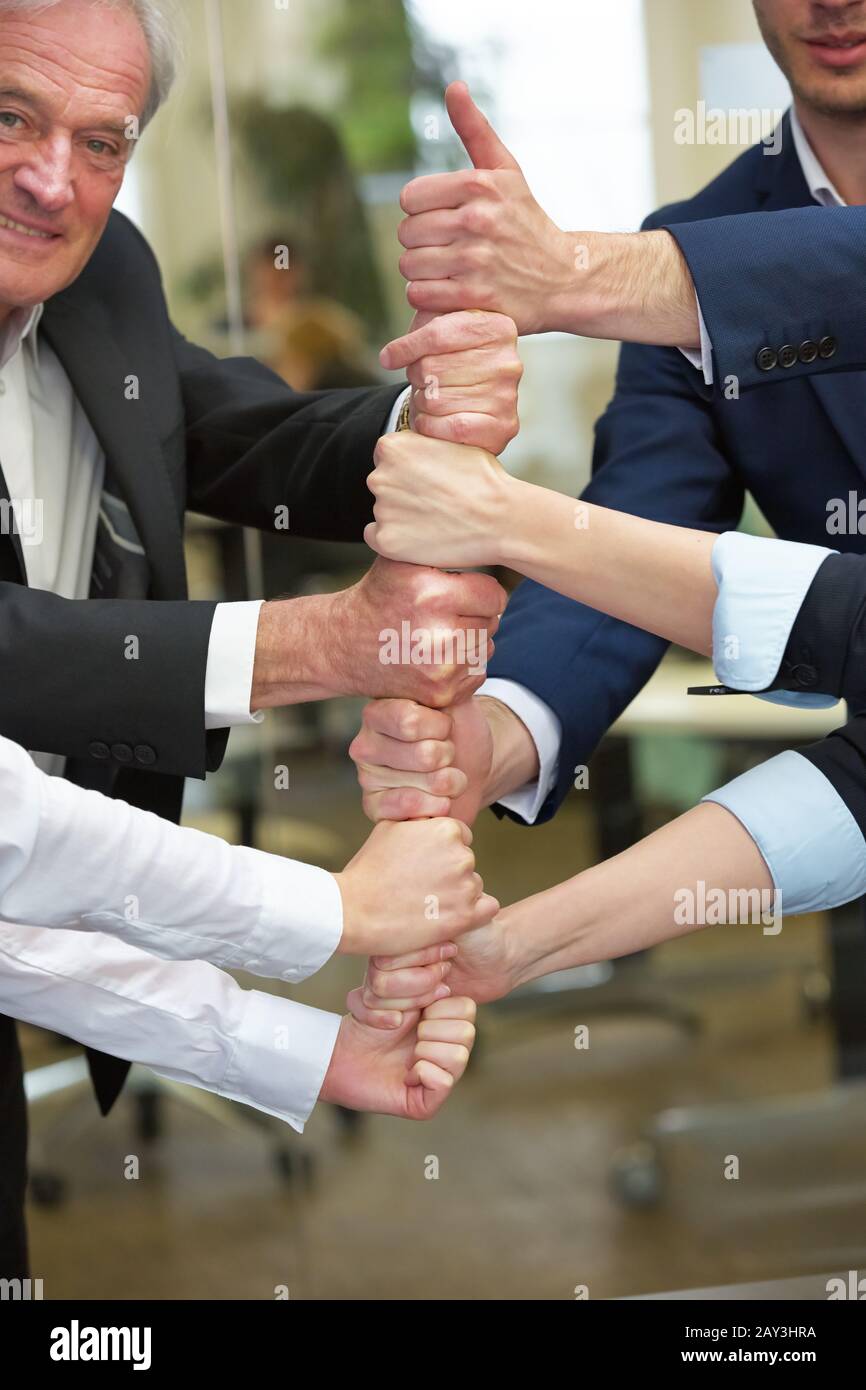 Many business people stack their fists for motivation Stock Photo - Alamy