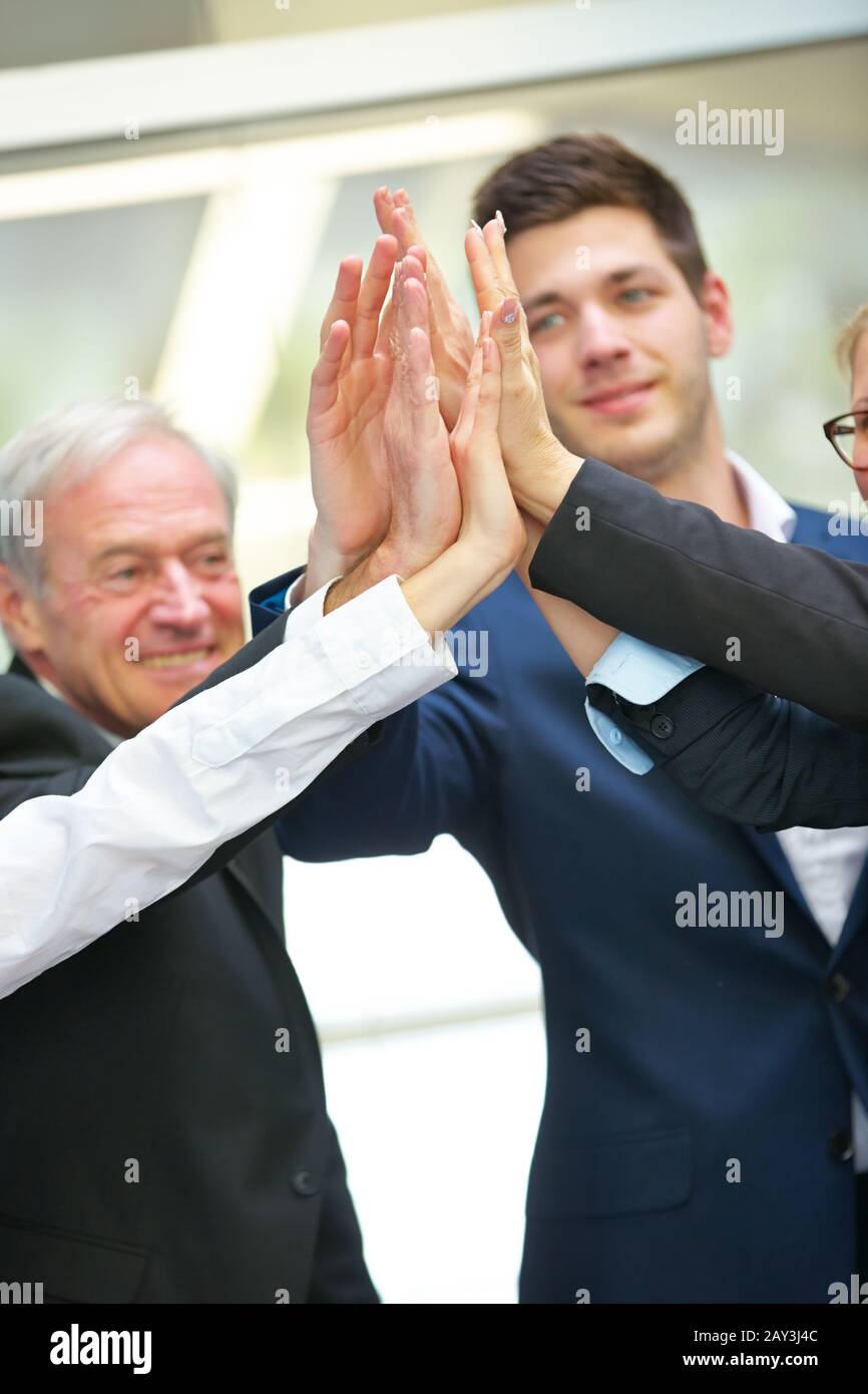 Hands of business people give themselves high five in the office Stock ...