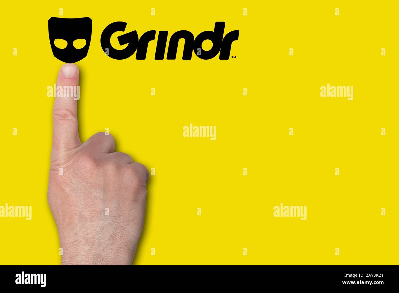 hand touching a Grindr logo Stock Photo - Alamy