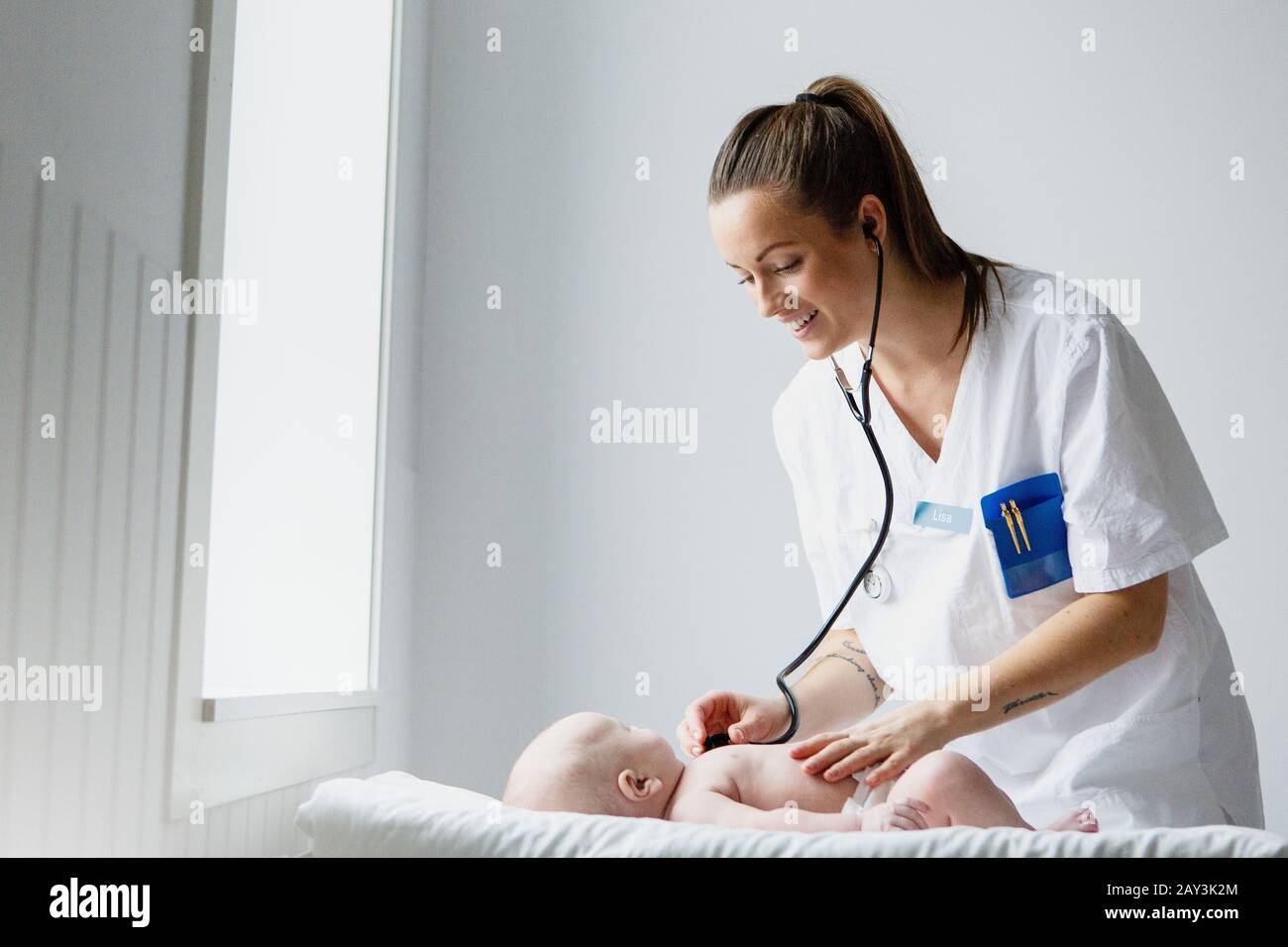 Doctor examining baby Stock Photo - Alamy