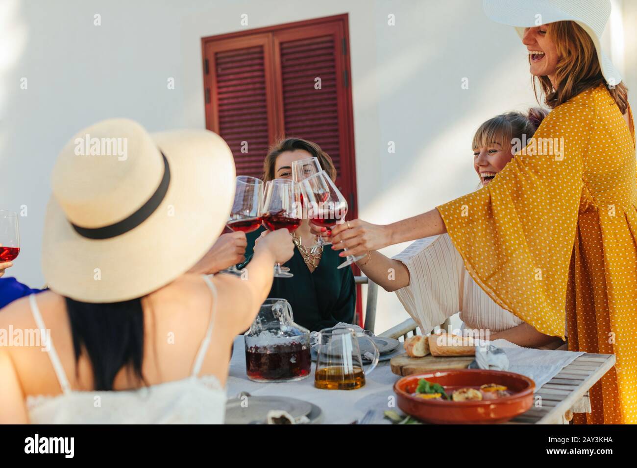 Happy female friends toasting Stock Photo - Alamy