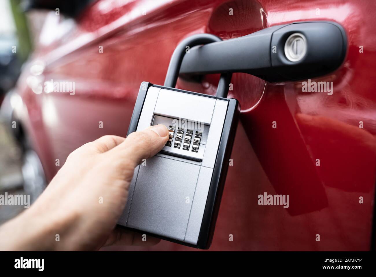 Hand Opening Key Safe Hanging On The Car Door With Keys Securely Stored ...