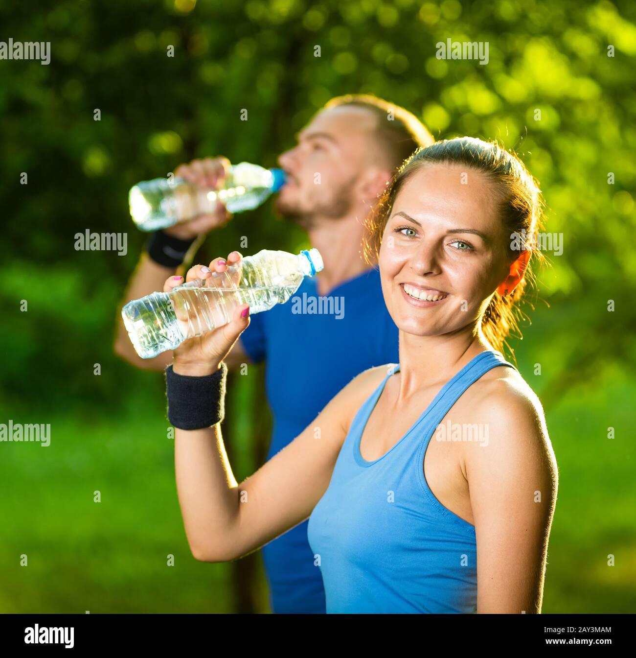 Young women drinking water two bottle hi-res stock photography and ...