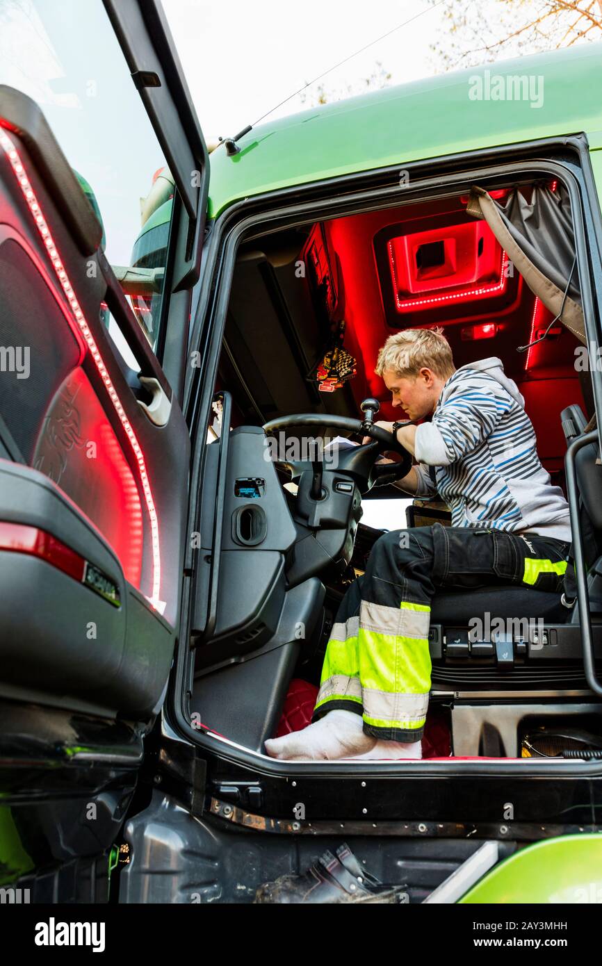 Lorry driver in vehicle cabin Stock Photo - Alamy