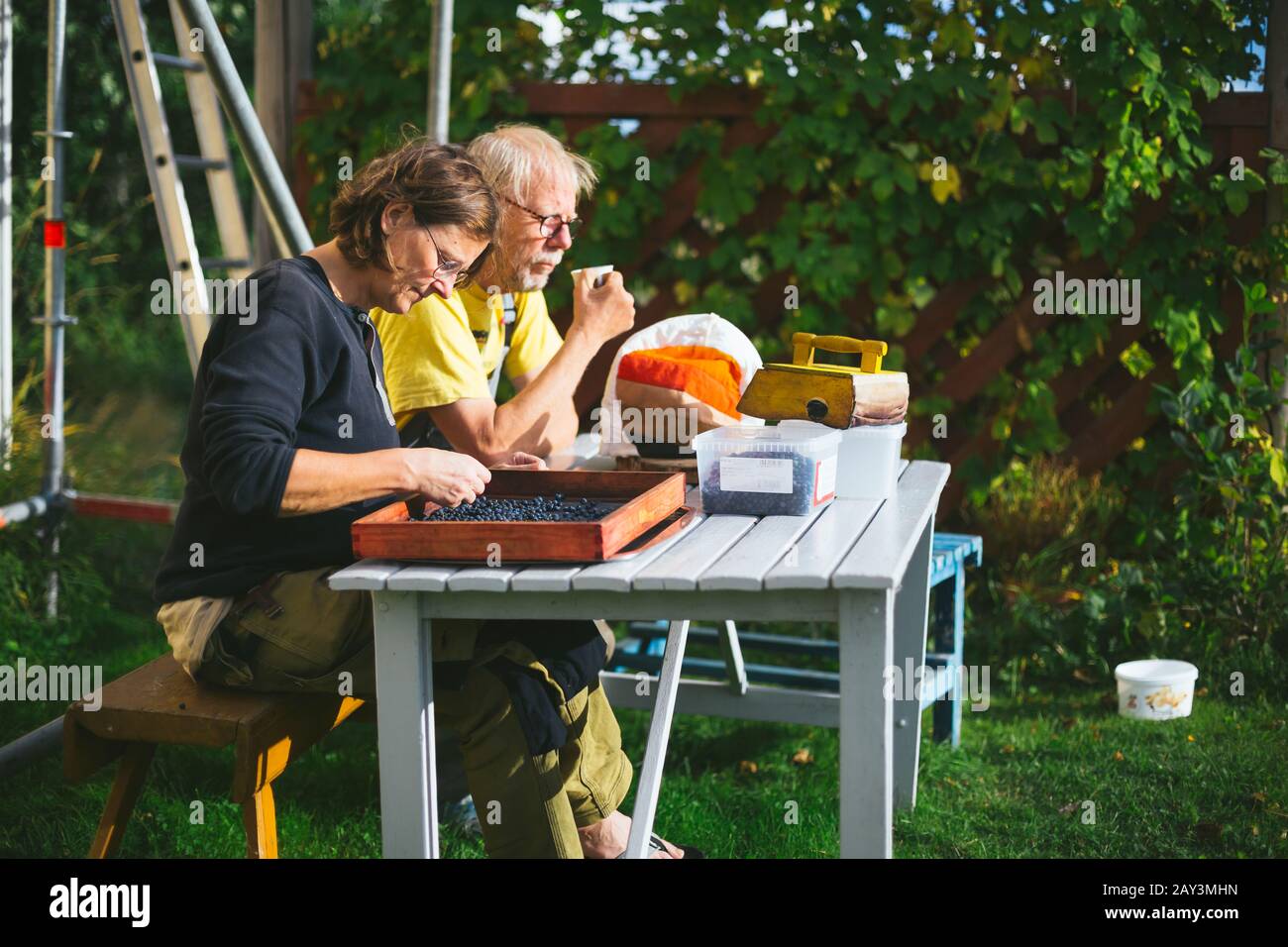 Couple sitting outside Stock Photo - Alamy