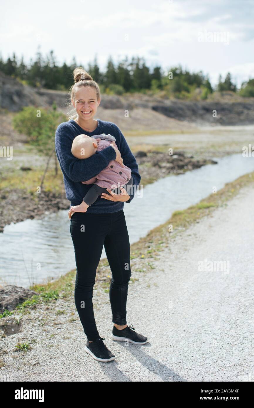 Woman carrying baby hi-res stock photography and images - Alamy