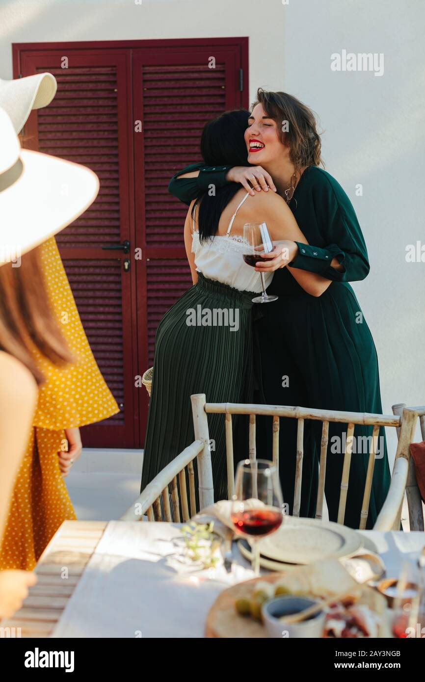 Women greeting one another Stock Photo - Alamy