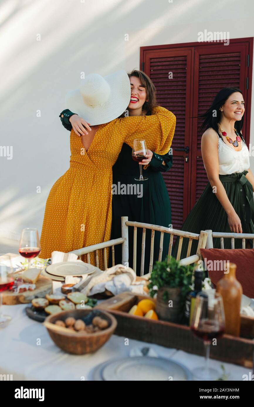 Women greeting one another Stock Photo - Alamy