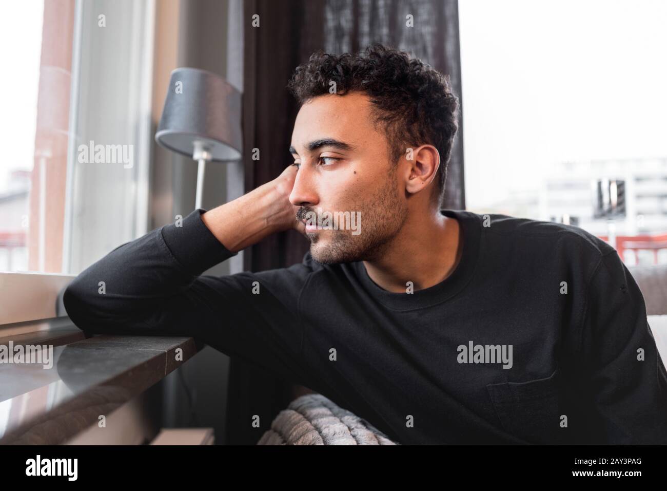 Man looking through window Stock Photo - Alamy