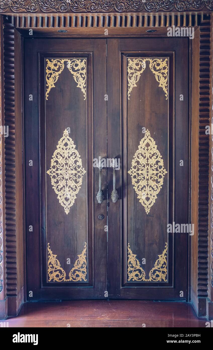 old vintage retro wooden door handle with art painting Stock Photo - Alamy