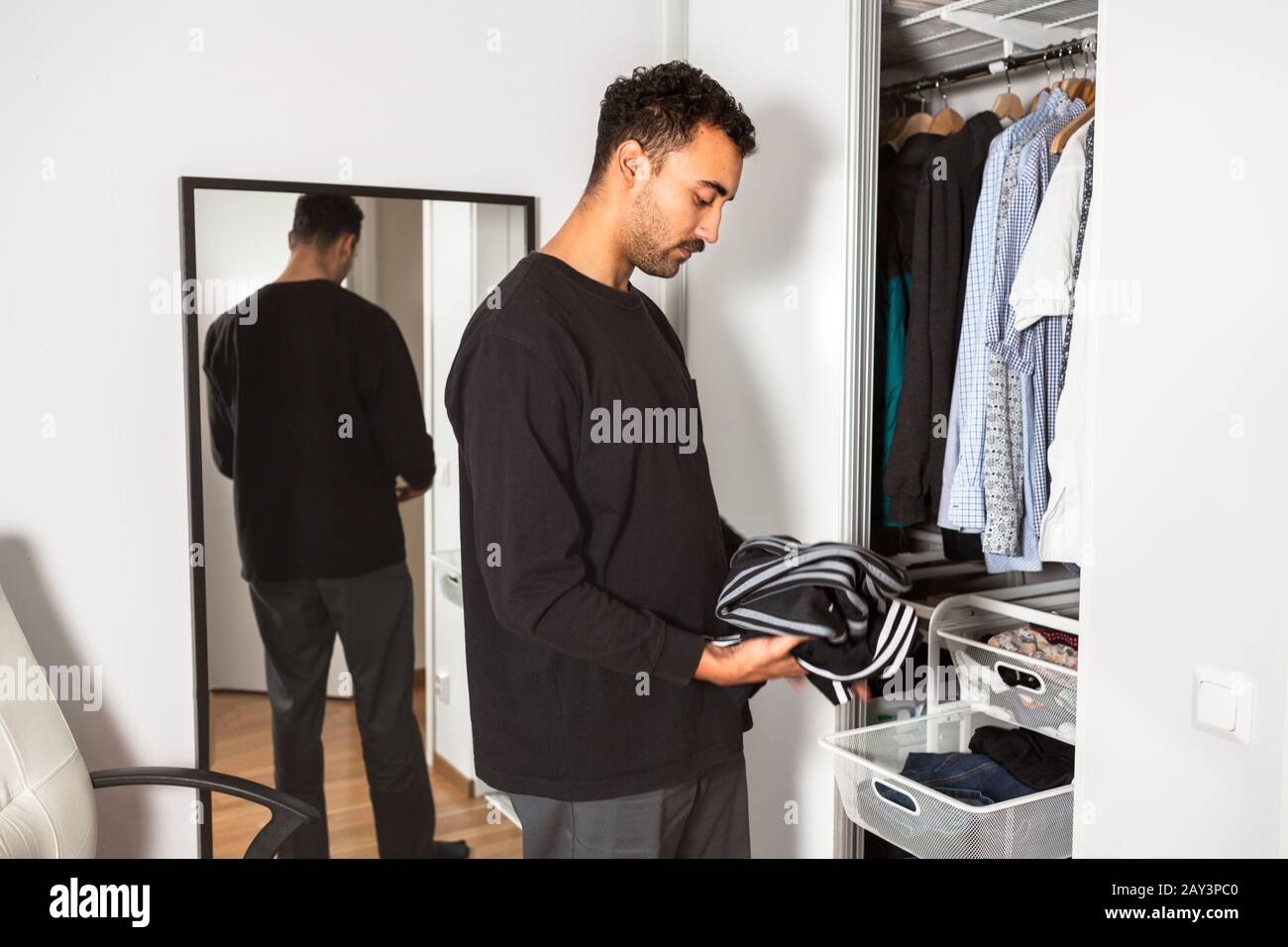 Man folding clothes Stock Photo - Alamy