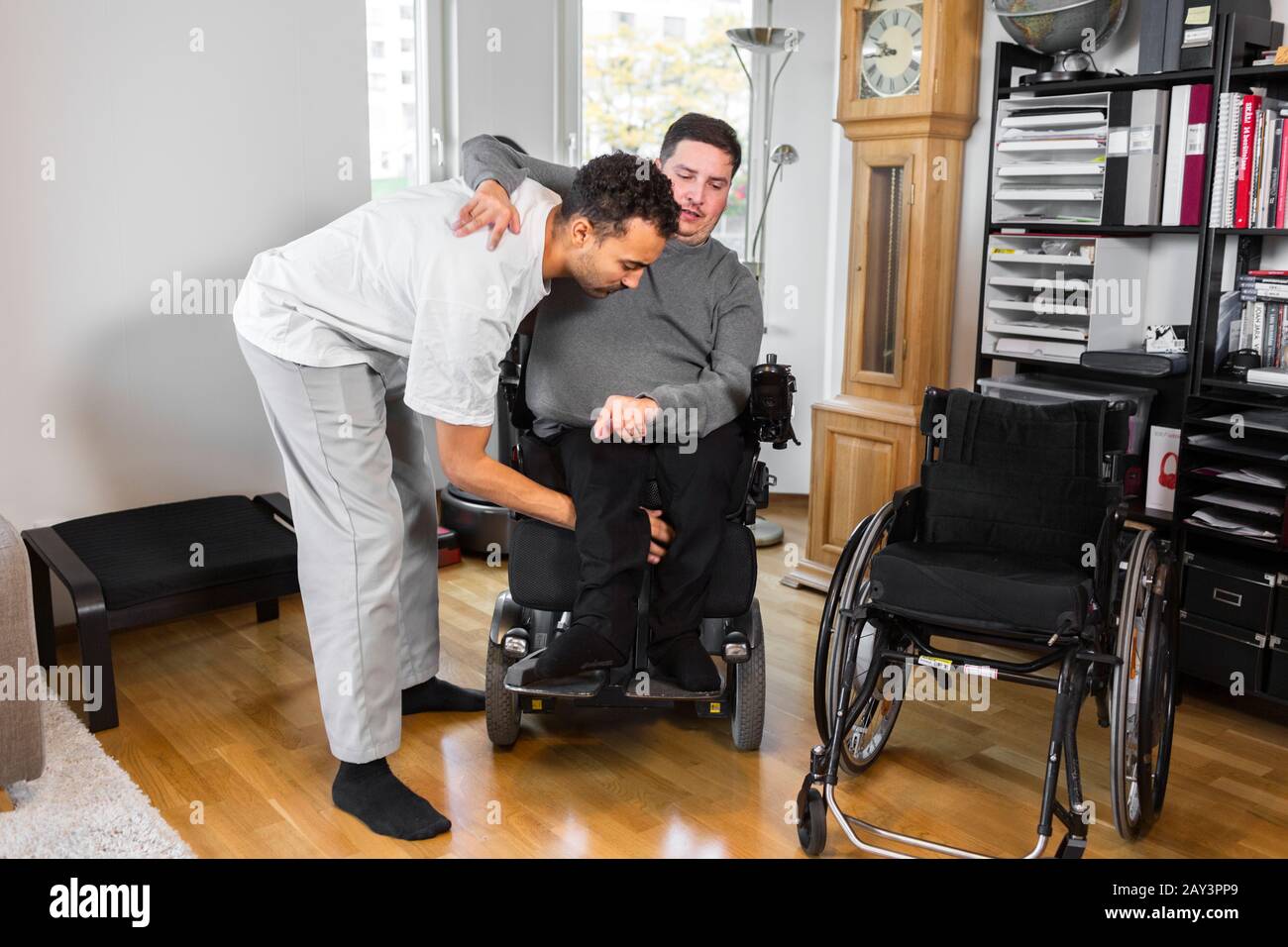Career helping man in wheelchair Stock Photo - Alamy